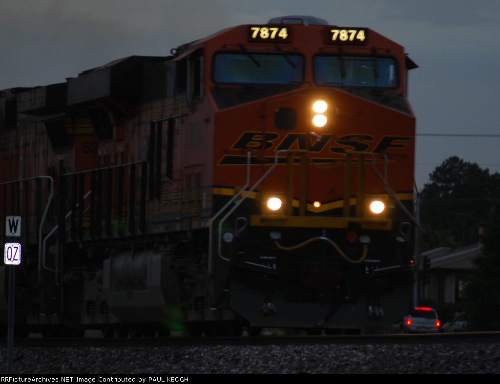 Close up.shot of the front end of BNSF 7874 as she rolls east at dusk.